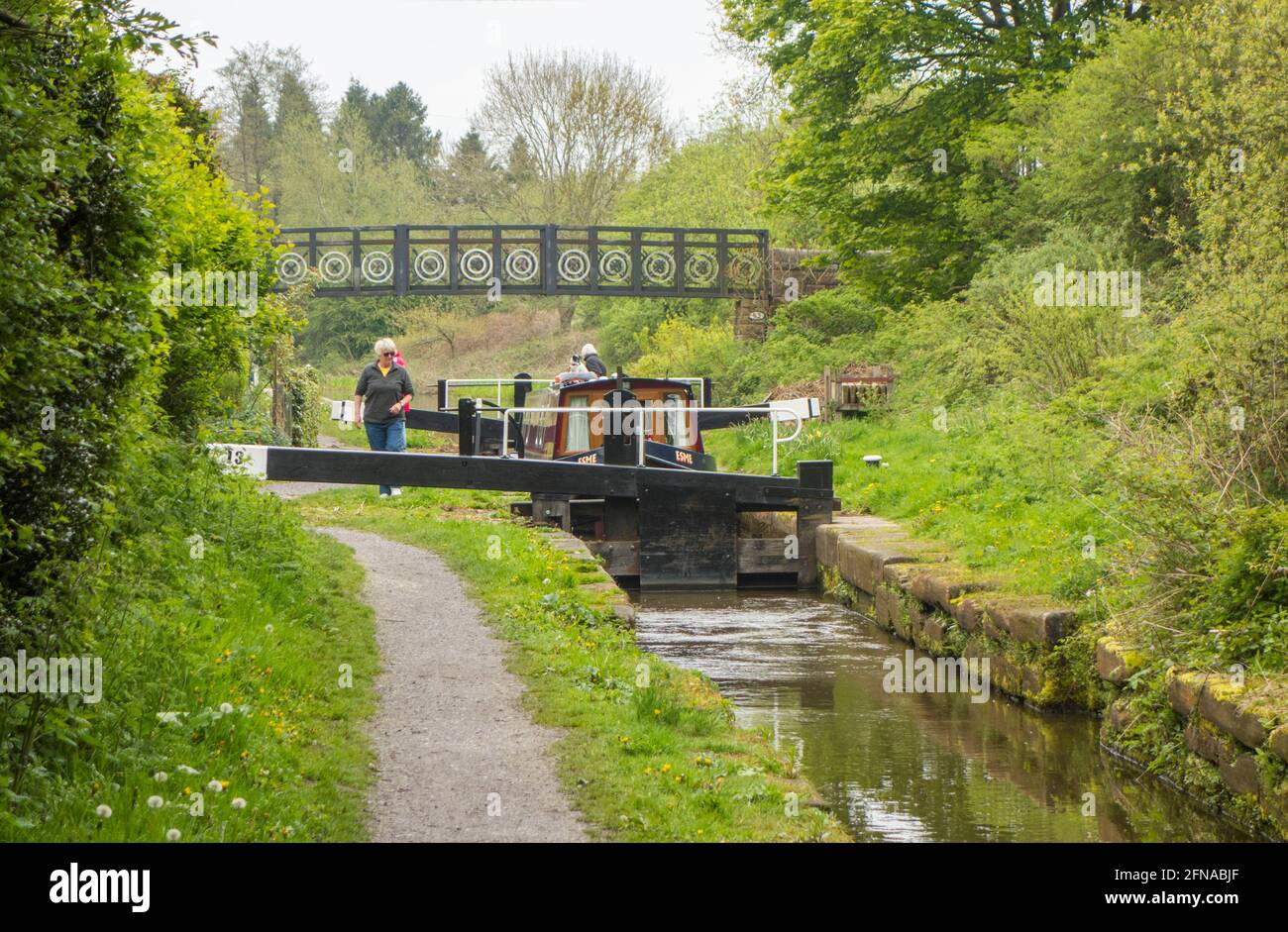 People on a Canal narrowboat as it passes through locks on the ...