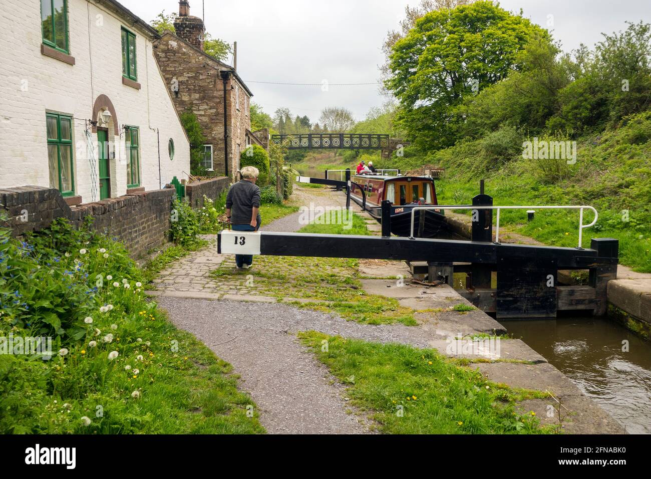 People on a Canal narrowboat as it passes through locks on the ...