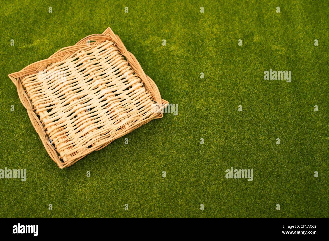 Vertical shot of a straw tray against a green grass background Stock ...