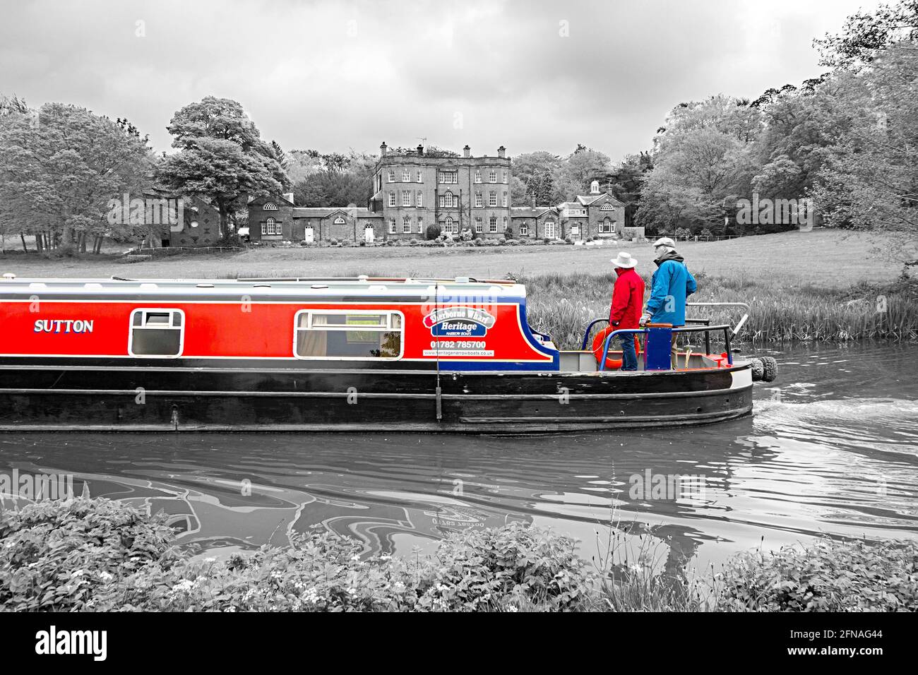 Canal narrowboat on the Macclesfield canal as it passes Ramsdell Hall ...