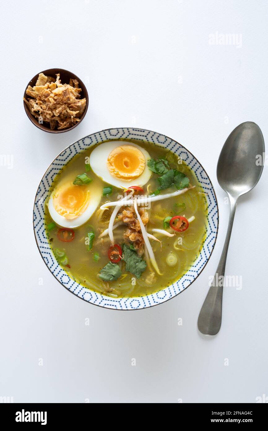 A single bowl of Soto Ayam (translation: Indonesian chicken soup) with ...