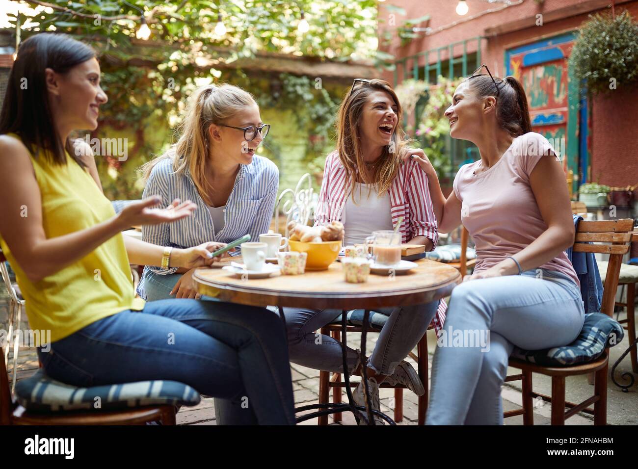 A group of female students are laughing while spending a good time in ...
