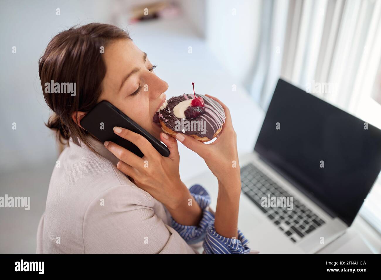 Woman desk snack unhealthy hi-res stock photography and images - Alamy