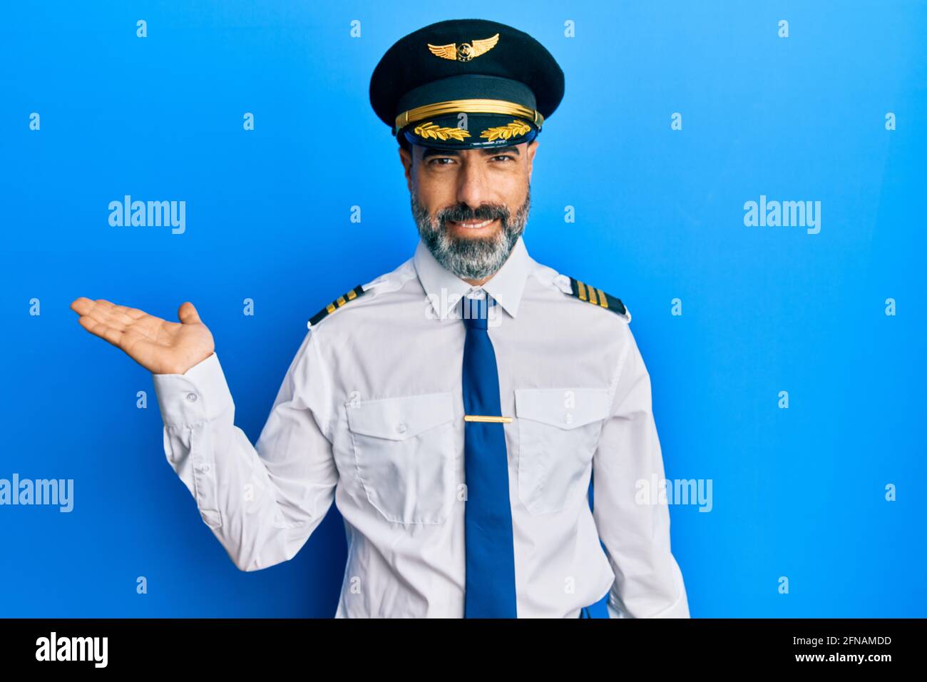 Middle age man with beard and grey hair wearing airplane pilot uniform ...