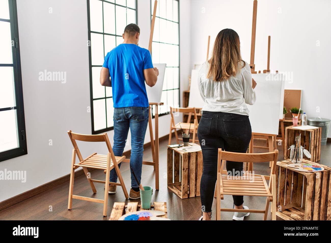 Two students on back view painting at art school Stock Photo - Alamy