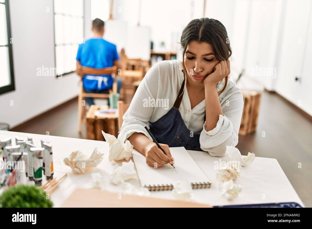 Paint student wpman stressed painting at art school Stock Photo - Alamy