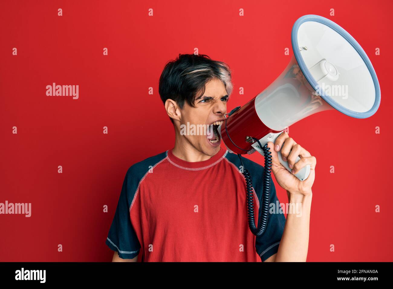 Young man shouting with anger and energy through megaphone Stock Photo ...