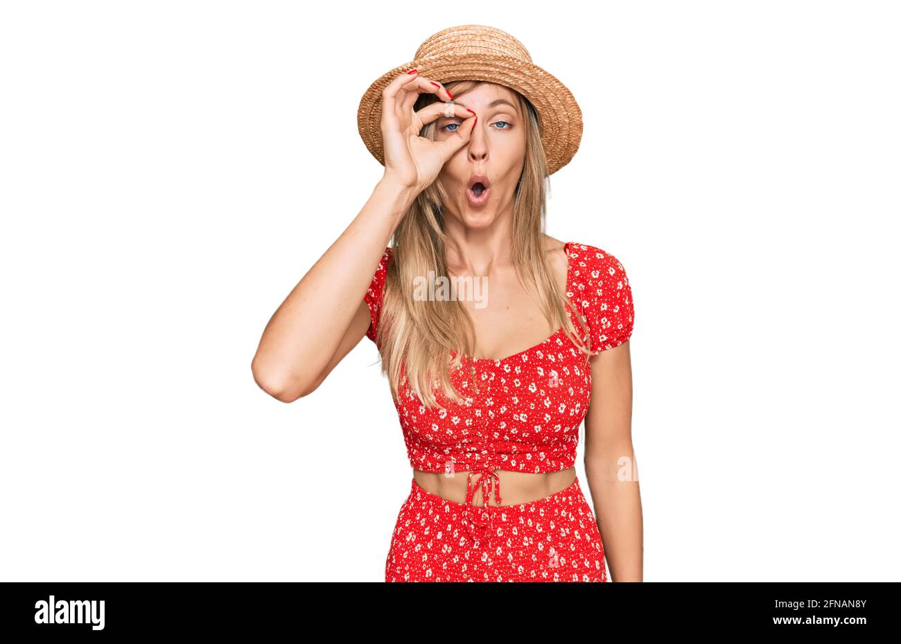 Beautiful caucasian woman wearing summer hat doing ok gesture shocked ...