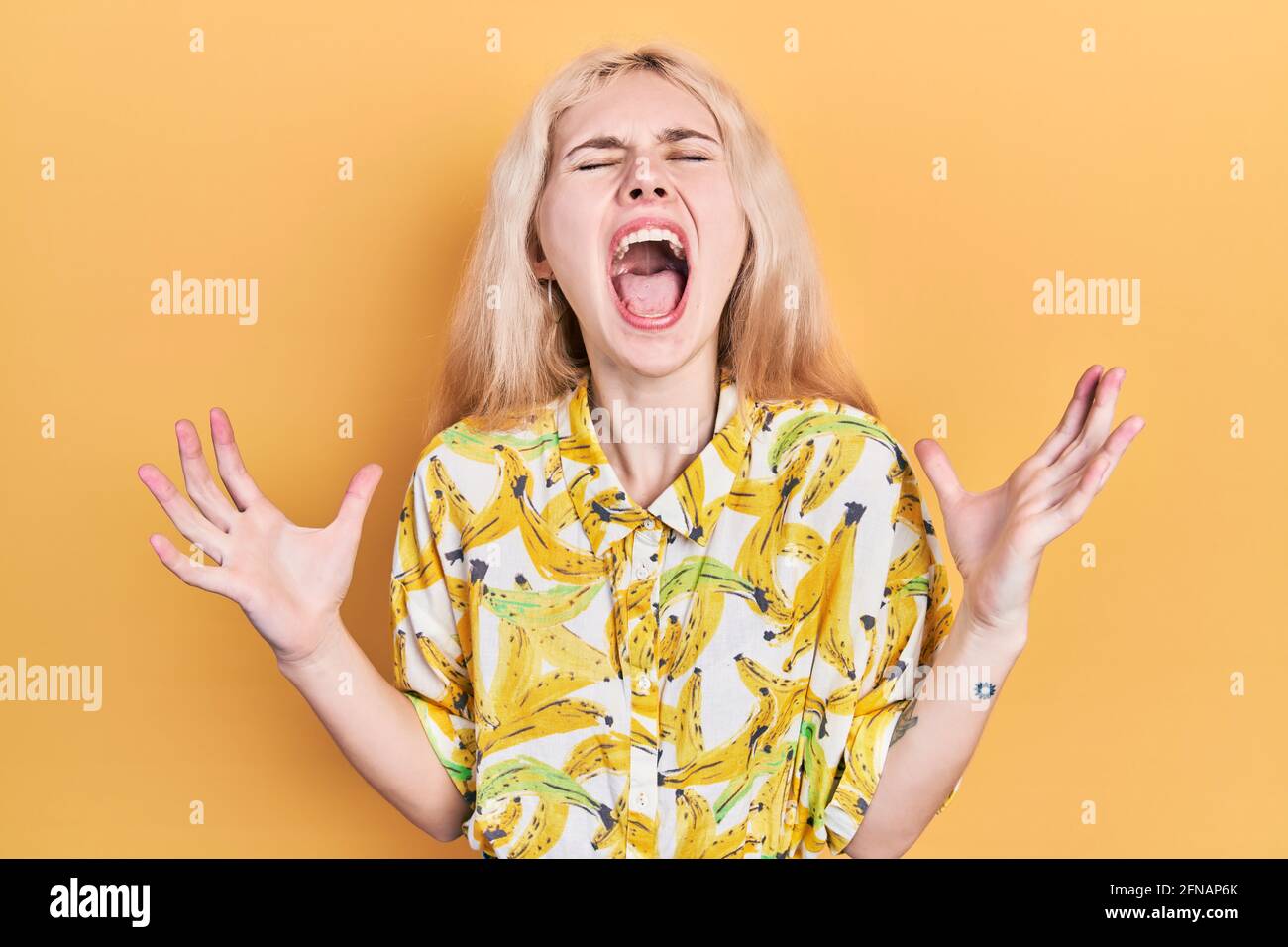Beautiful caucasian woman with blond hair wearing colorful shirt crazy ...