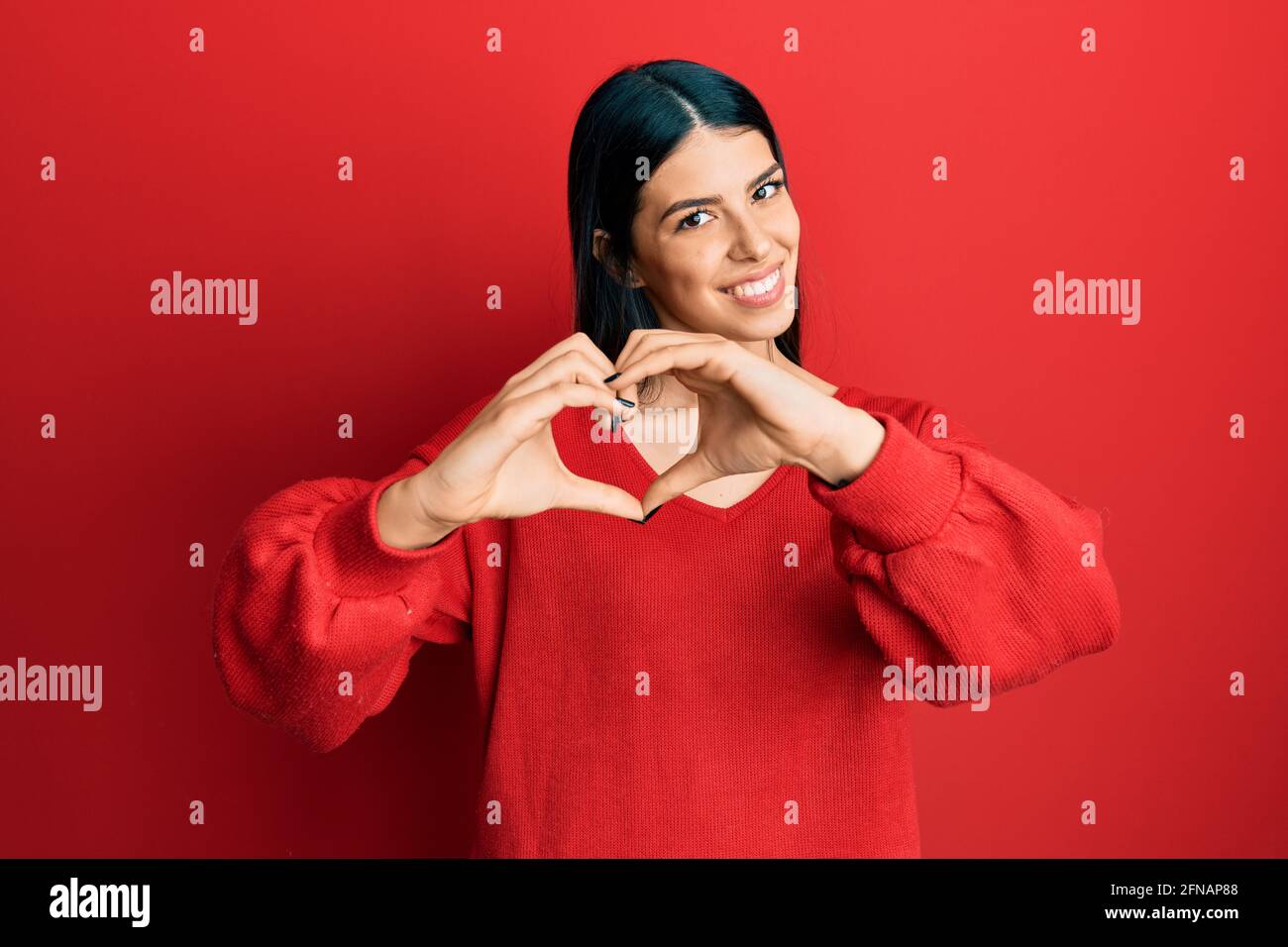 Young hispanic woman wearing casual clothes smiling in love showing ...