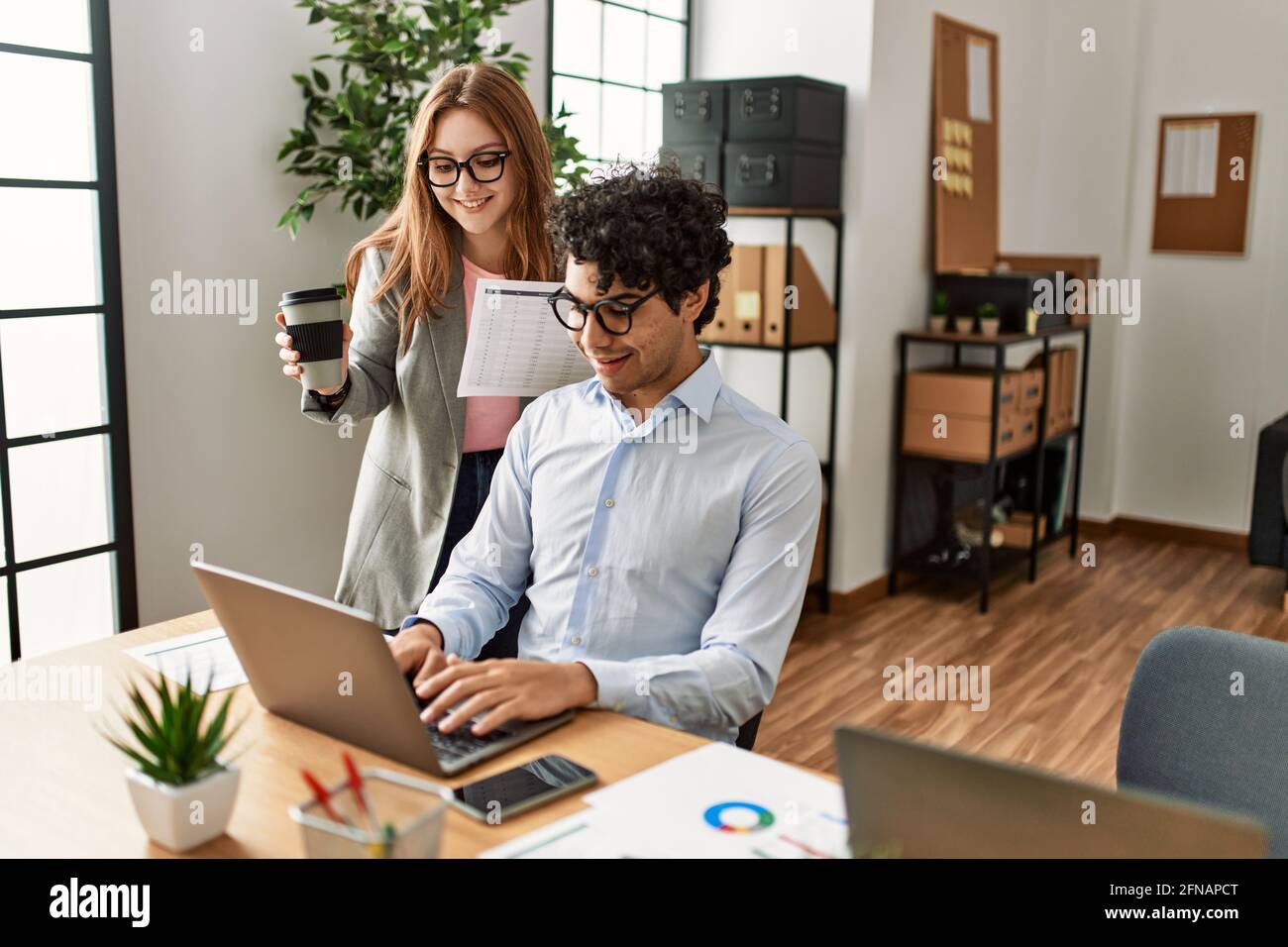 Two business workers smiling happy working at the office Stock Photo ...