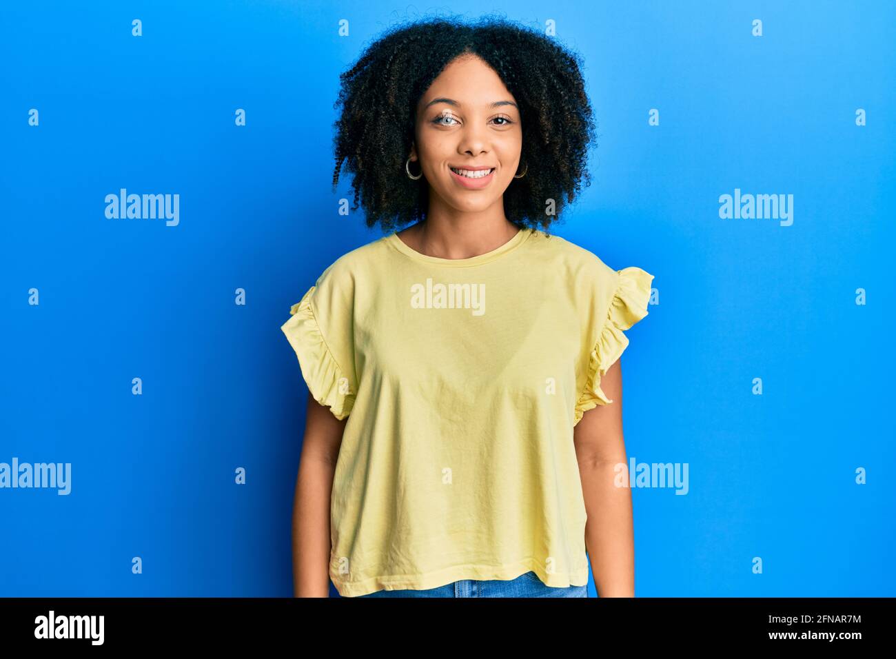 Young african american girl wearing casual clothes with a happy and ...