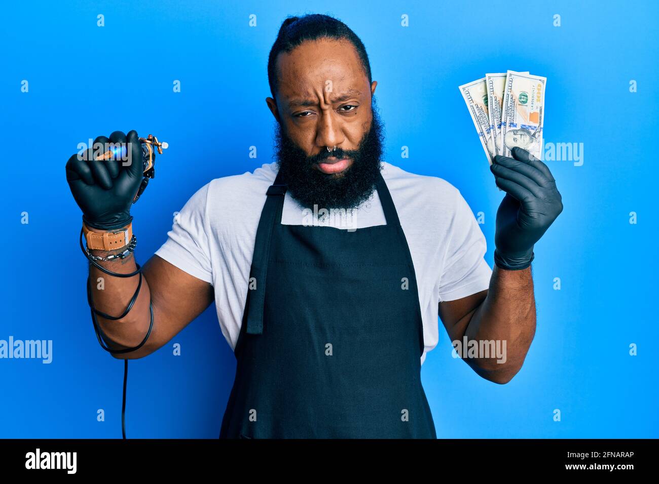 Tattooist wearing black gloves hi-res stock photography and images - Alamy