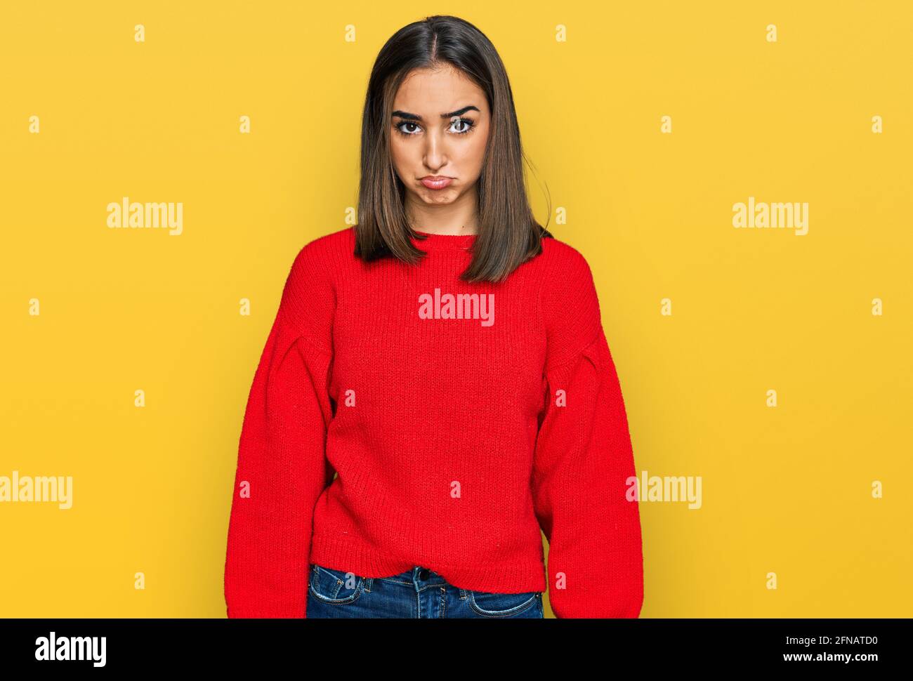 Beautiful brunette woman wearing casual winter sweater depressed and ...