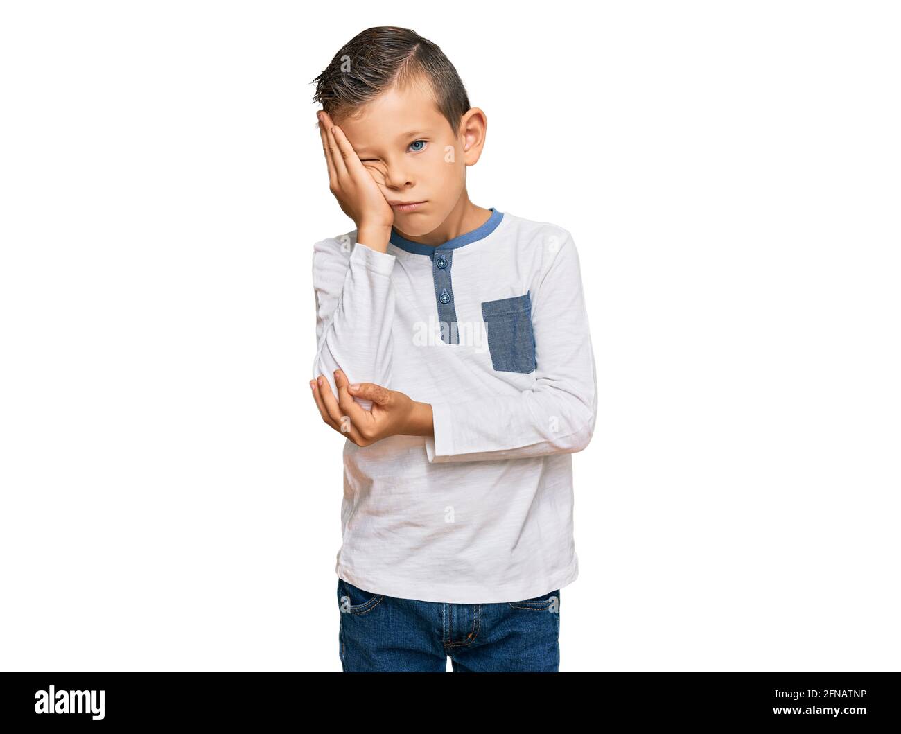 Adorable caucasian kid wearing casual clothes thinking looking tired ...
