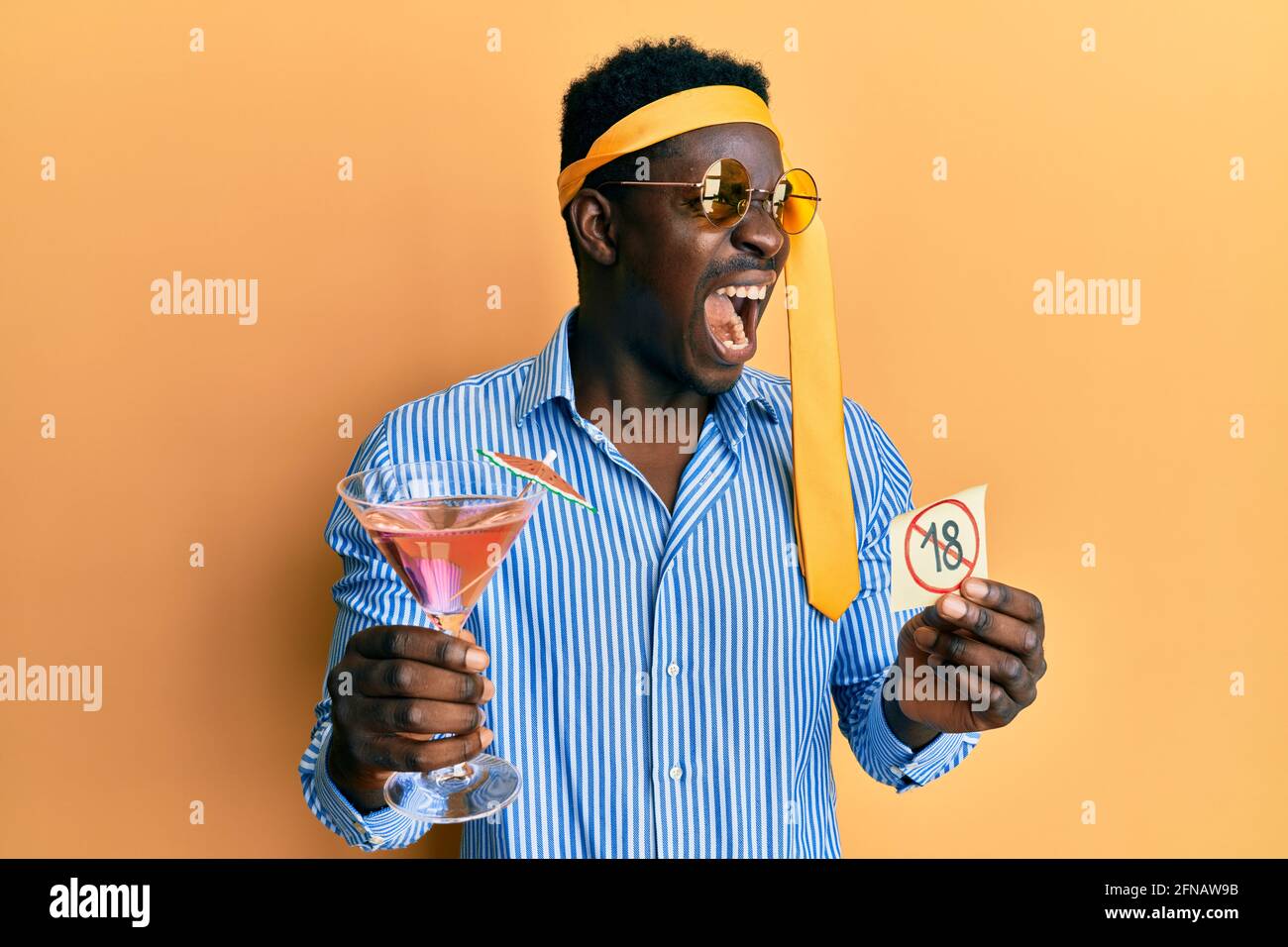 Handsome black man drunk wearing tie over head drinking cocktail ...