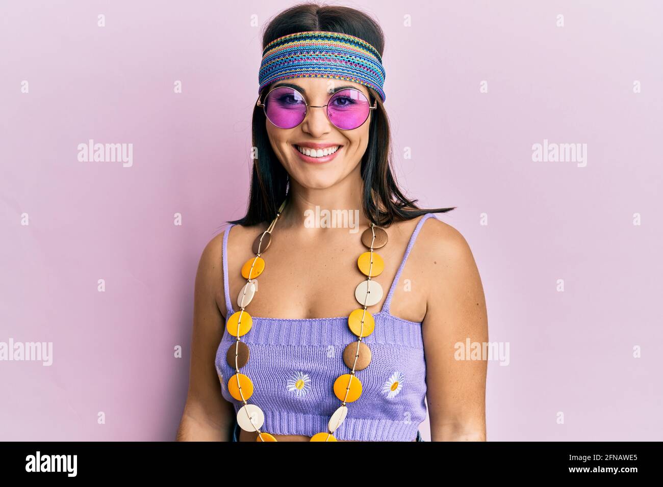 Young brunette woman wearing bohemian and hippie style looking positive ...