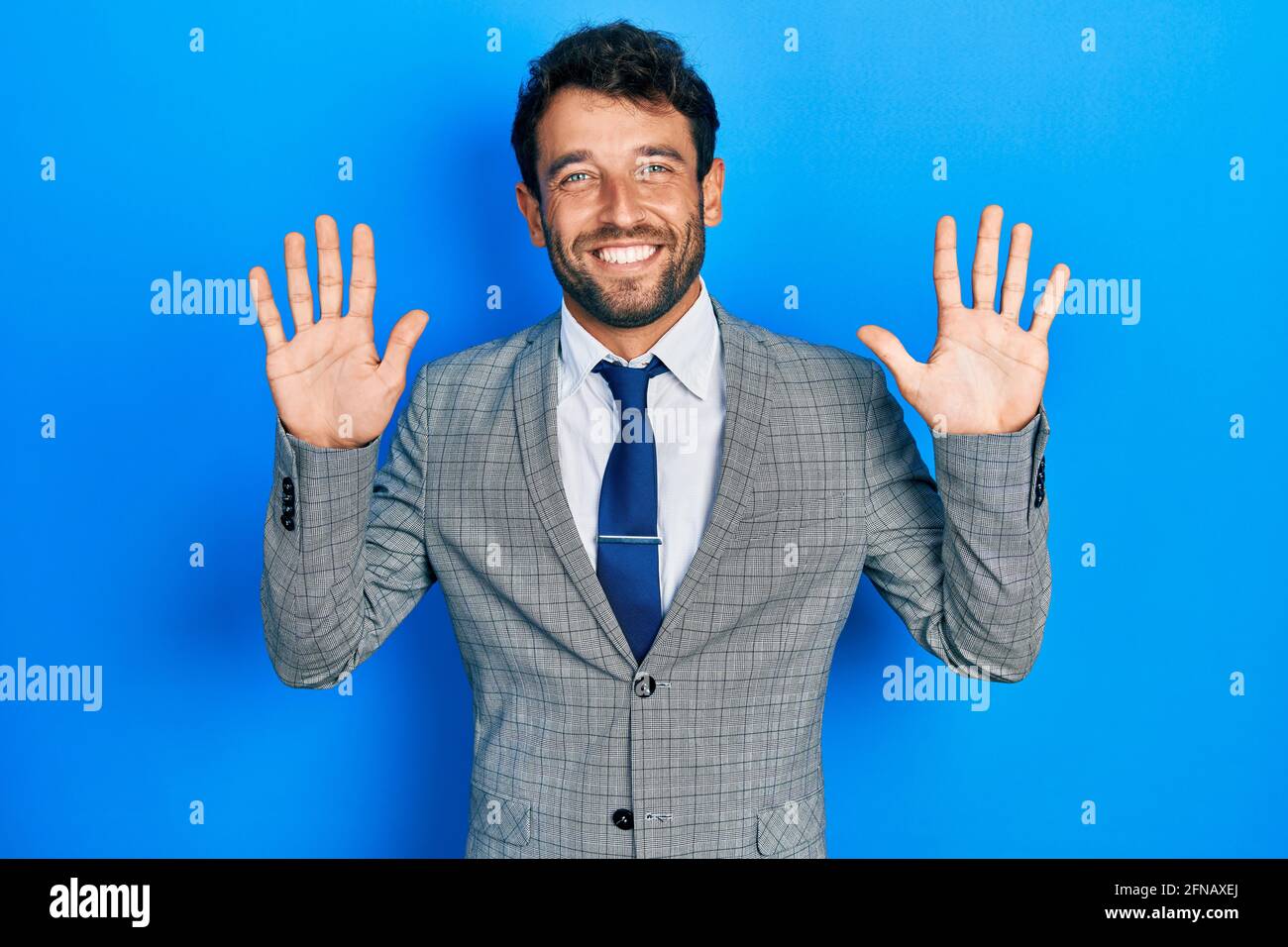 Handsome man with beard wearing business suit and tie showing and ...