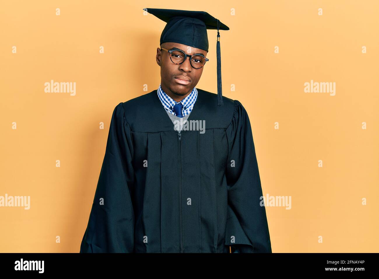 Young african american man wearing graduation cap and ceremony robe ...