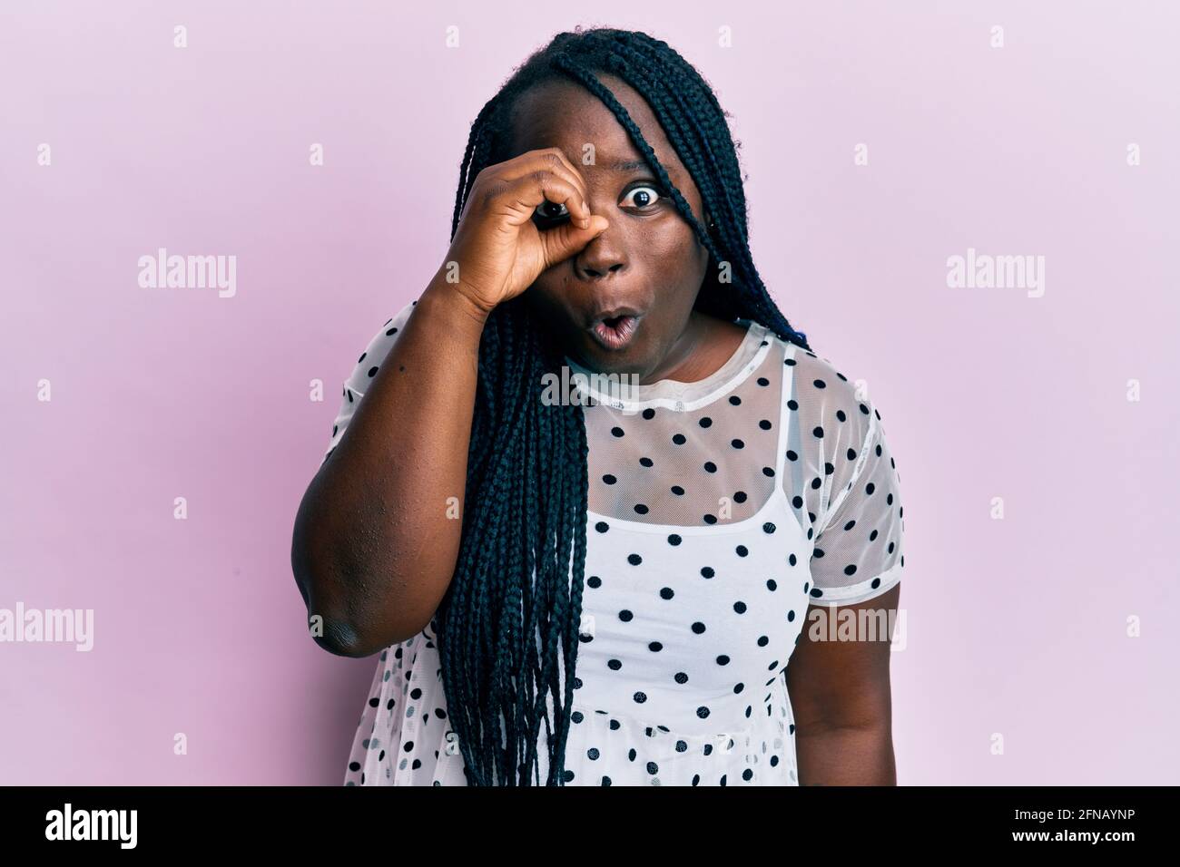 Young black woman with braids wearing casual clothes doing ok gesture ...