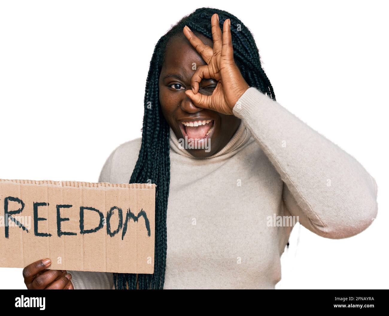 Young black woman with braids holding freedom banner smiling happy ...