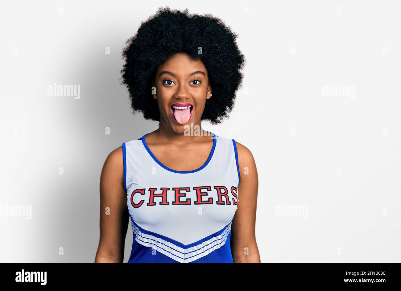 Young african american woman wearing cheerleader uniform sticking ...