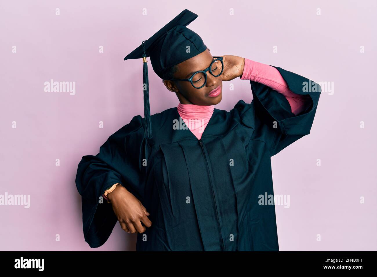 Young african american girl wearing graduation cap and ceremony robe ...