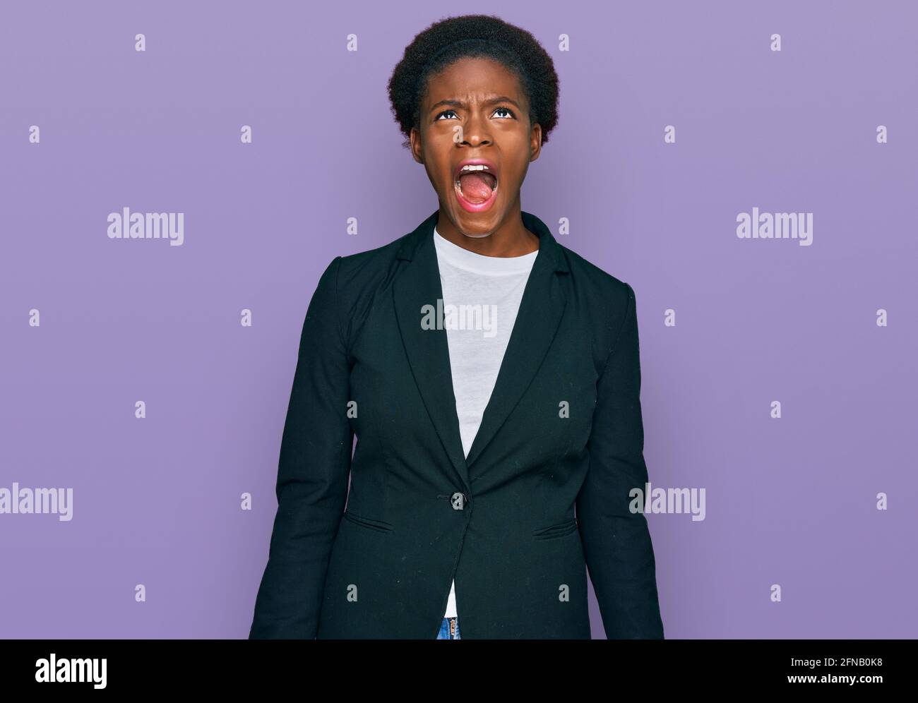 Young african american girl wearing business clothes angry and mad ...