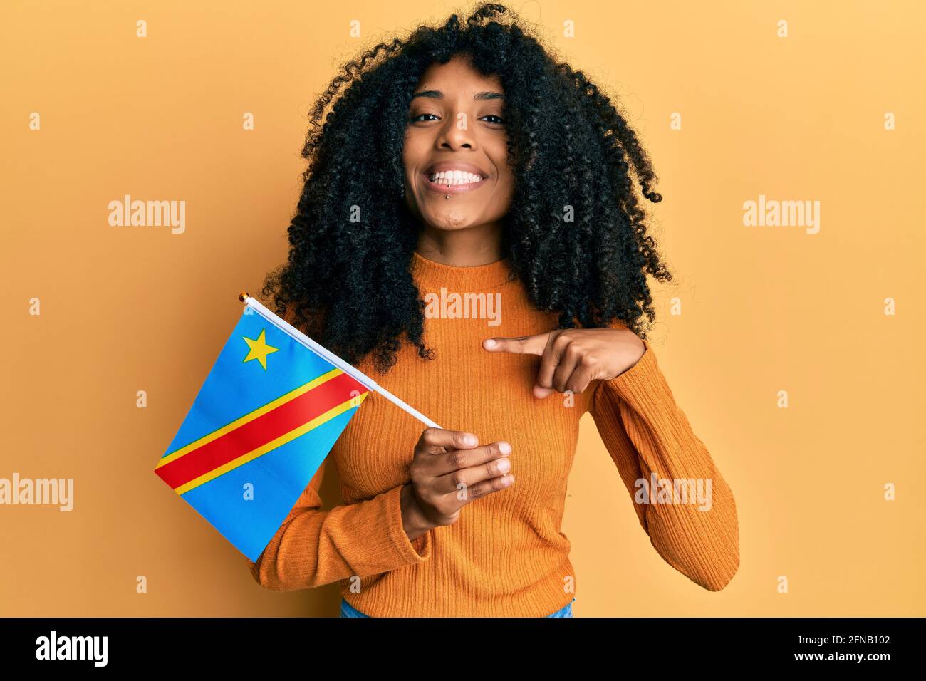 African american woman with afro hair holding democratic republic of ...