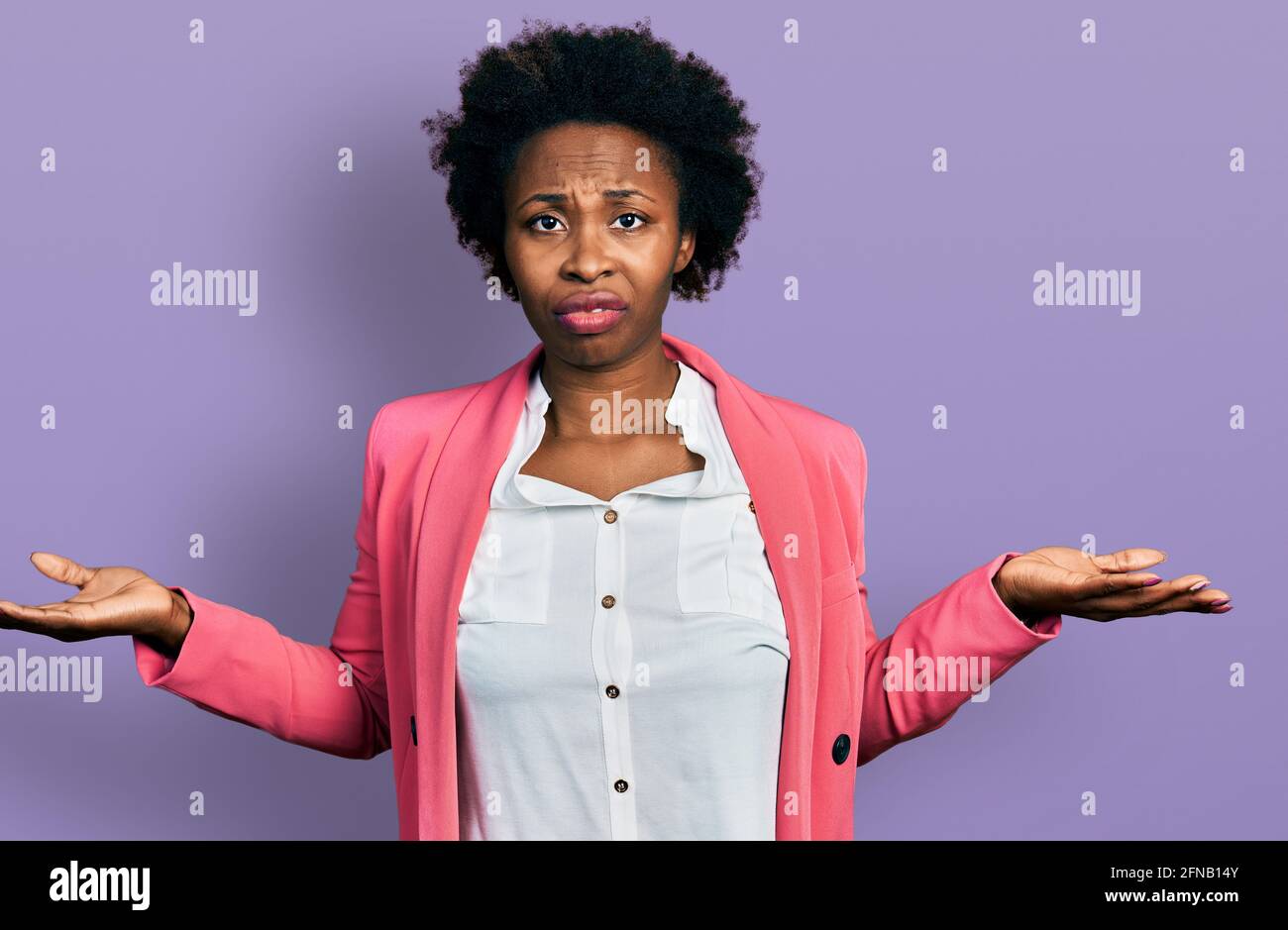 African american woman with afro hair wearing business jacket clueless ...