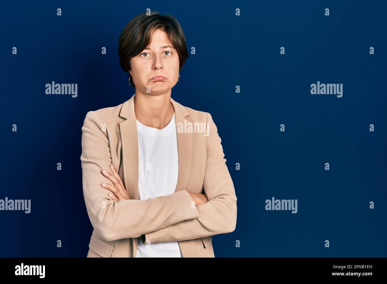 Young caucasian woman with arms crossed gesture depressed and worry for ...
