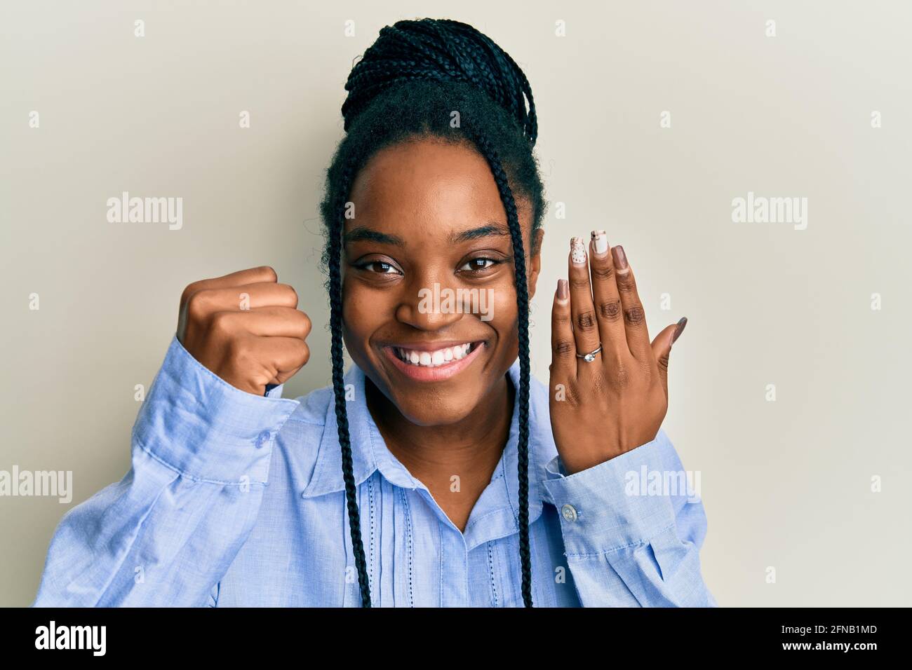 African american woman with braided hair wearing engagement ring ...