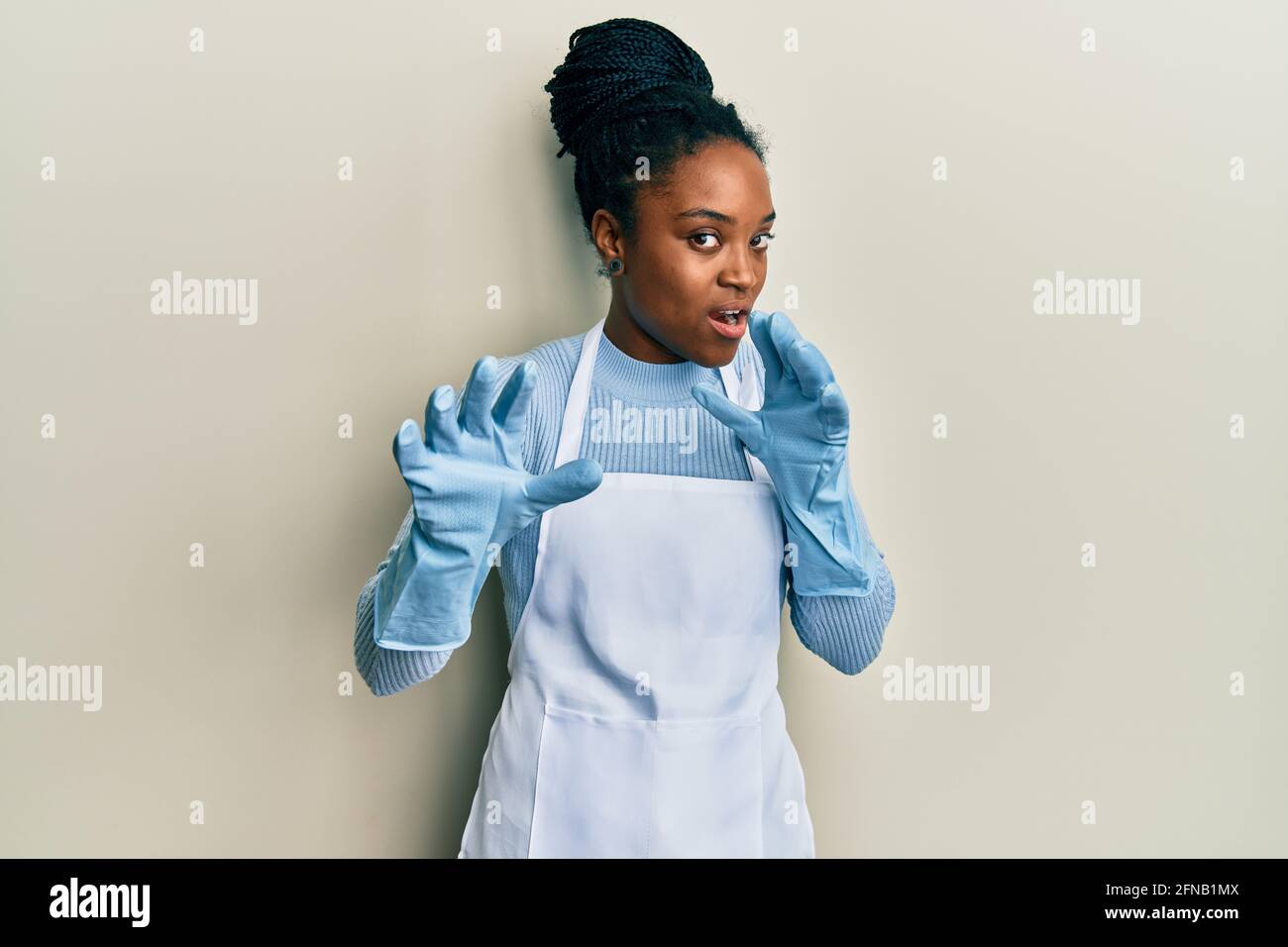 African american woman with braided hair wearing cleaner apron and ...