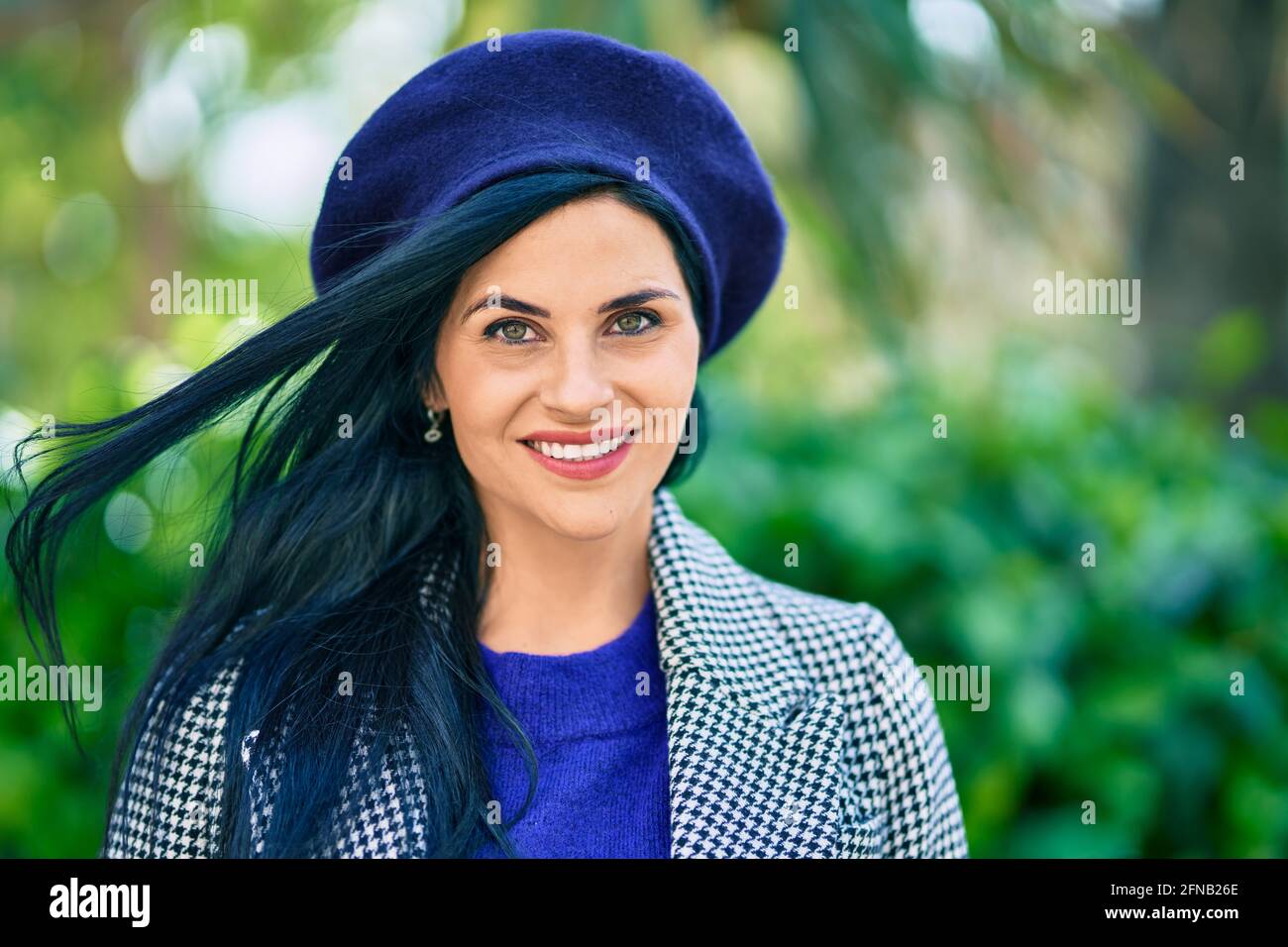 Young beautiful woman smiling happy wearing french style at the park ...