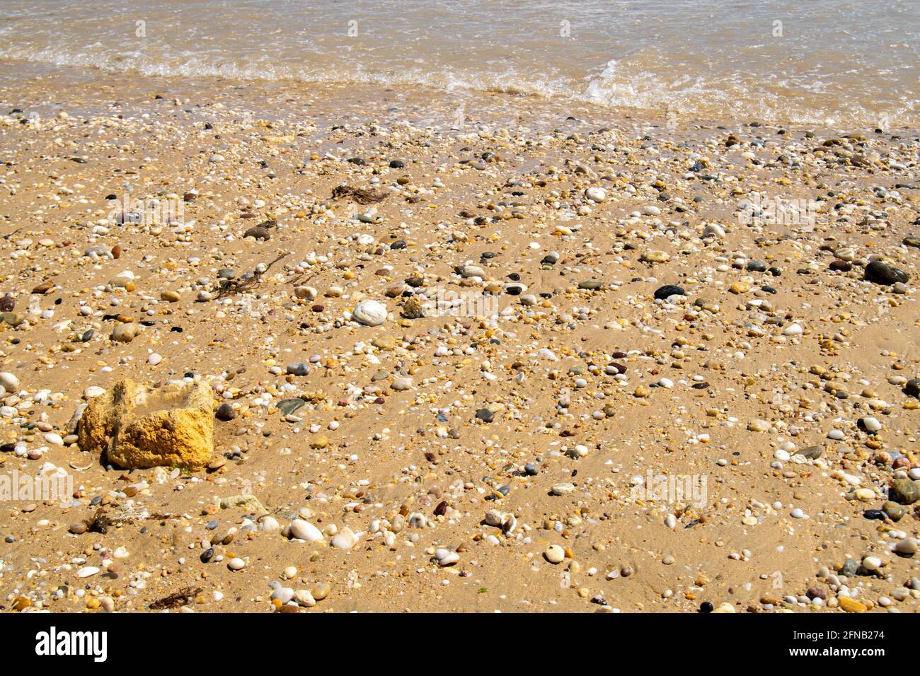 Beach sand ground with small sea rocks and small broken wave Stock ...