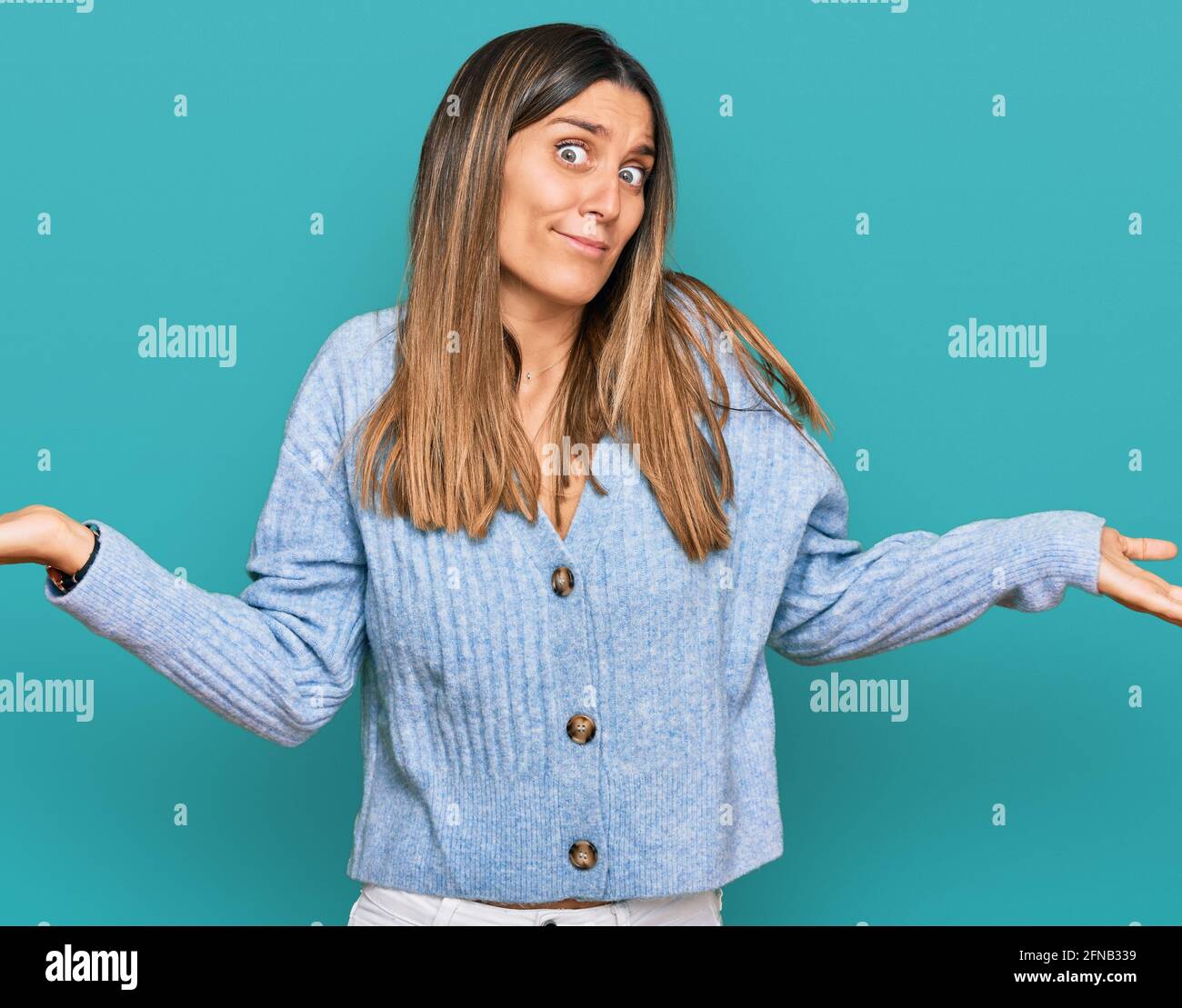Young woman wearing casual clothes clueless and confused expression ...