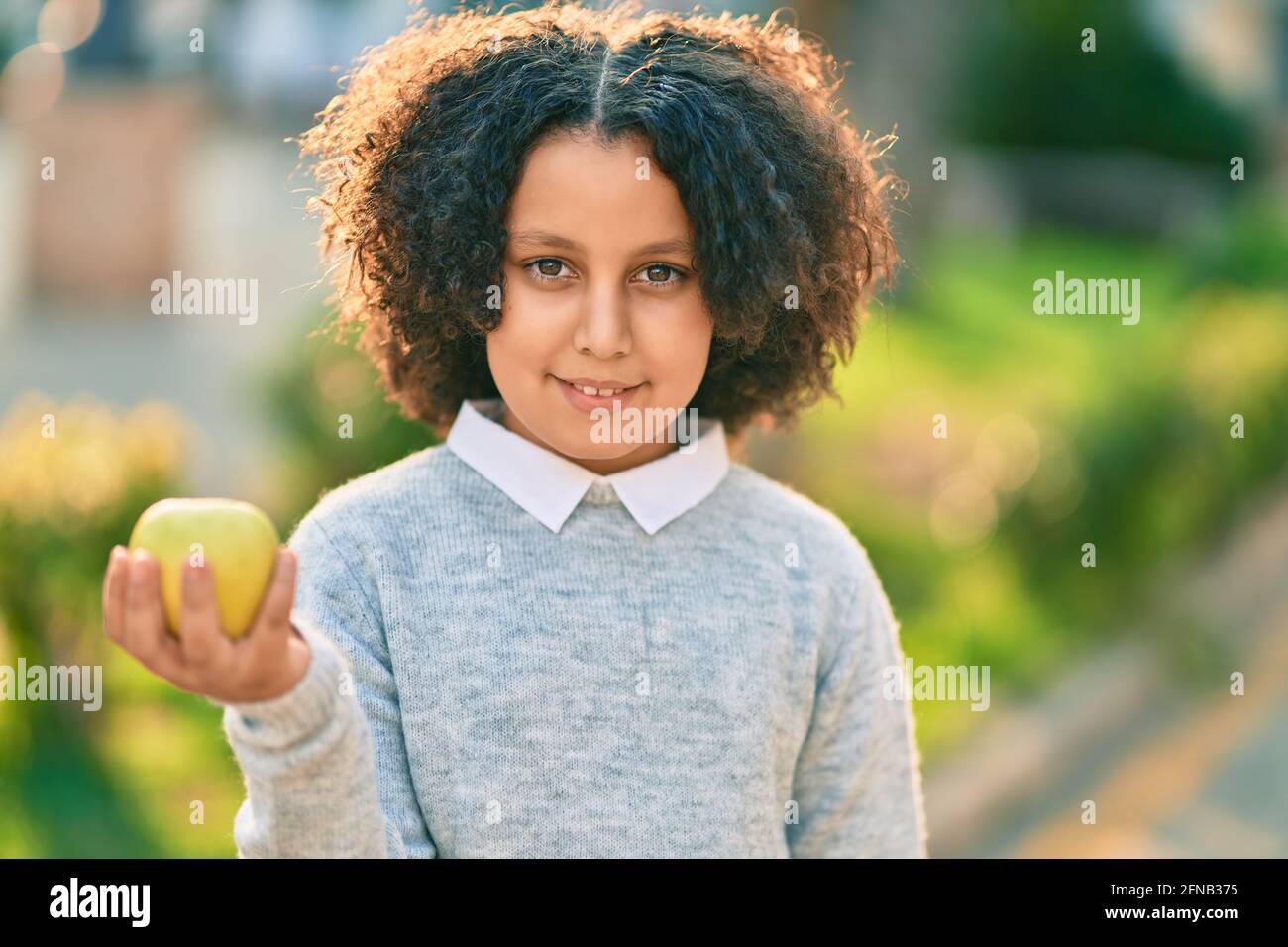 Adorable hispanic child girl smiling happy standing at the park Stock ...