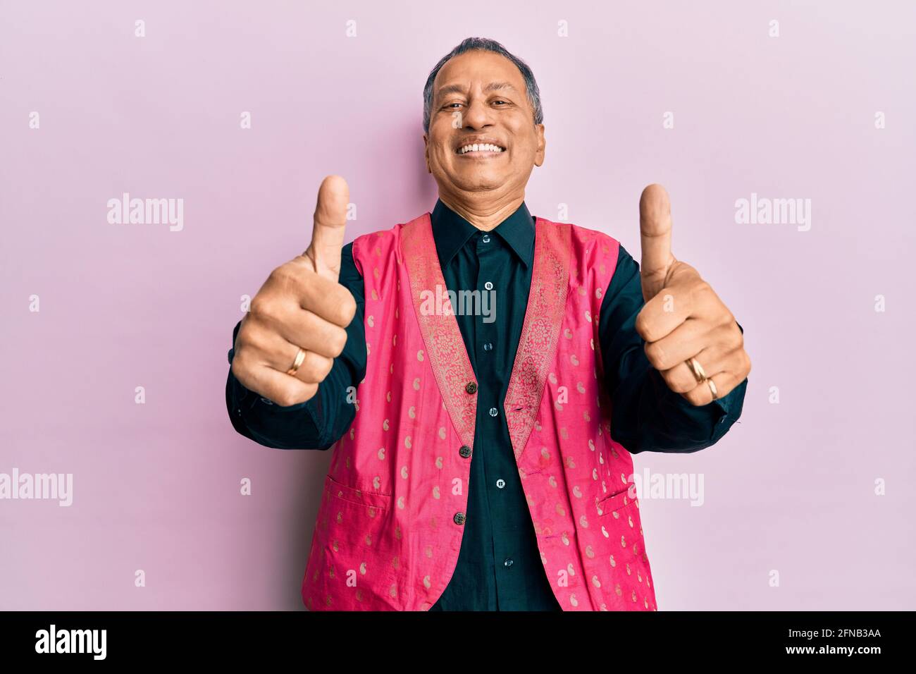 Middle age indian man wearing traditional indian clothes approving ...