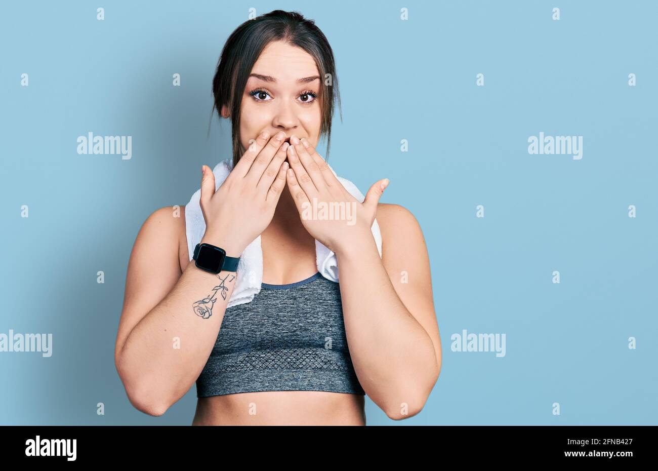 Young hispanic girl wearing sportswear and towel laughing and ...