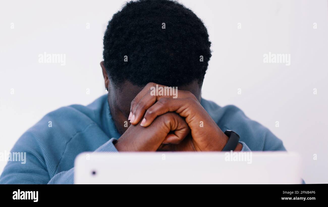 Stressed out man working on his laptop. Work stress or work load ...