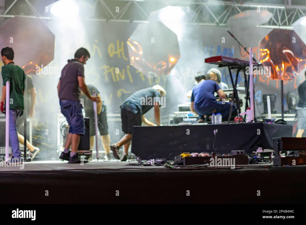 Roadies or riggers working on stage preparing the next show ir ...