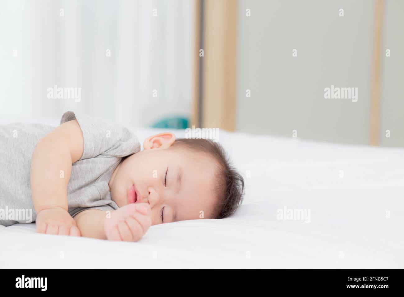 Portrait of asian little baby girl sleeping on bed in the bedroom at ...