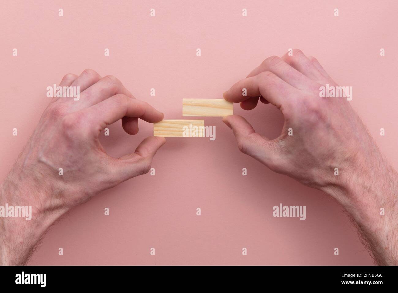 Hand comparing two wooden blocks. Business choice concept Stock Photo ...
