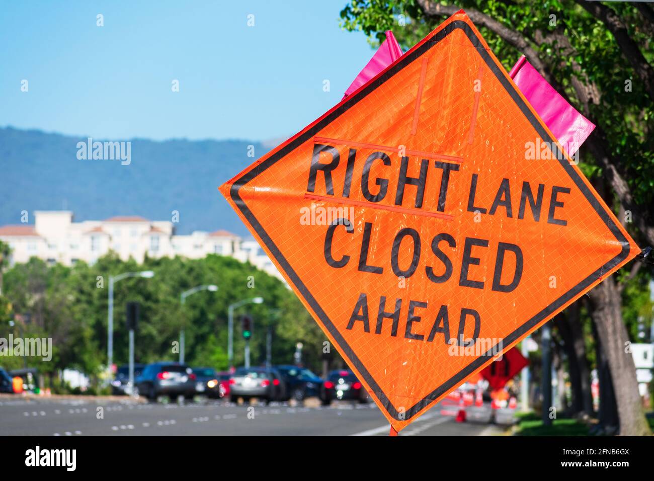 Right Lane Closed Ahead warning road sign on wide city street in urban ...