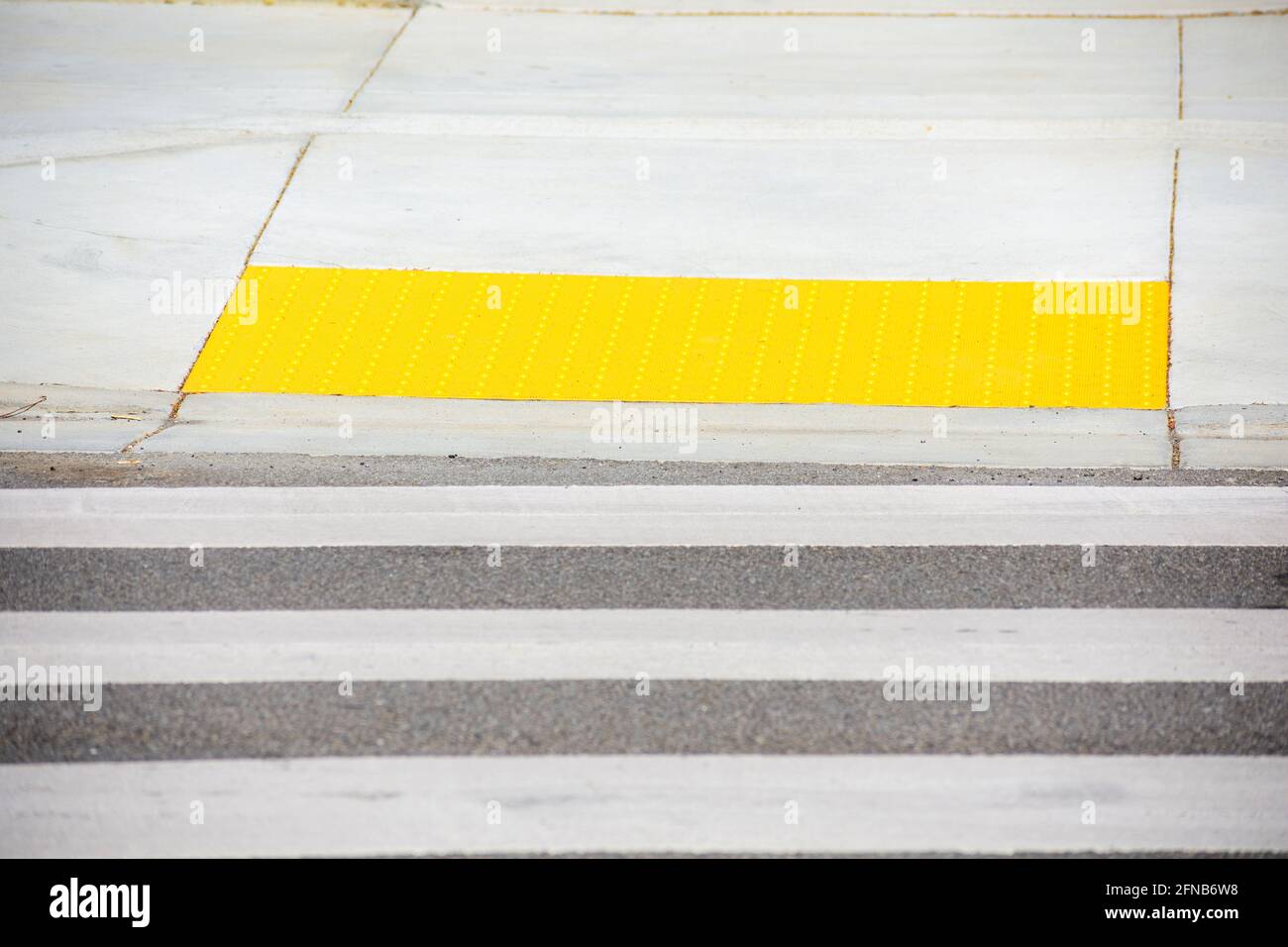 Pedestrian crossing leads to yellow detectable warning surface tactile ...