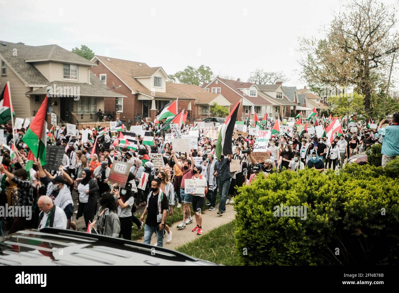 Protesters march through the streets with flags and placards during a ...