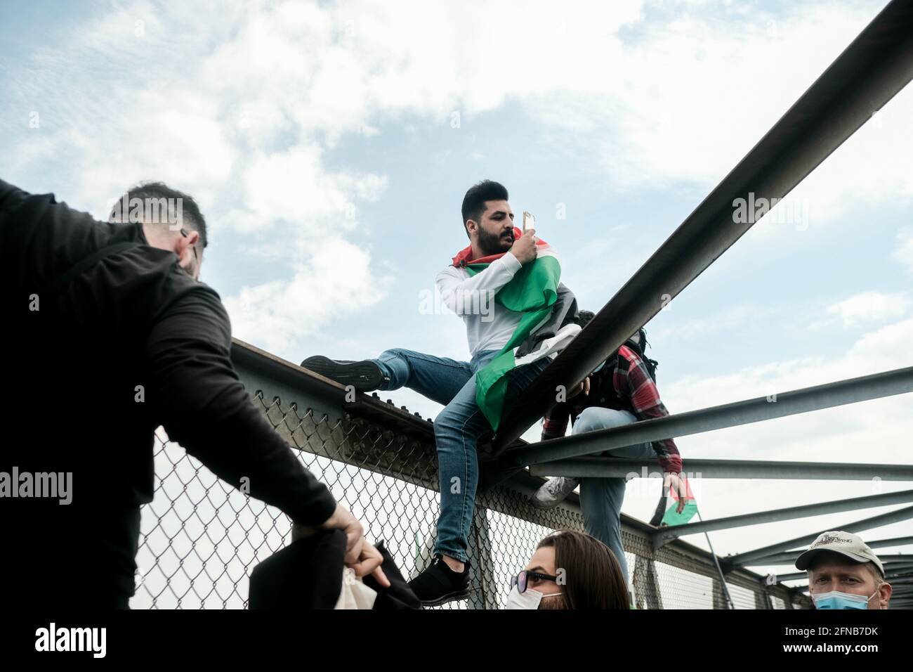 People watch as protesters march through the streets of Dearborn ...