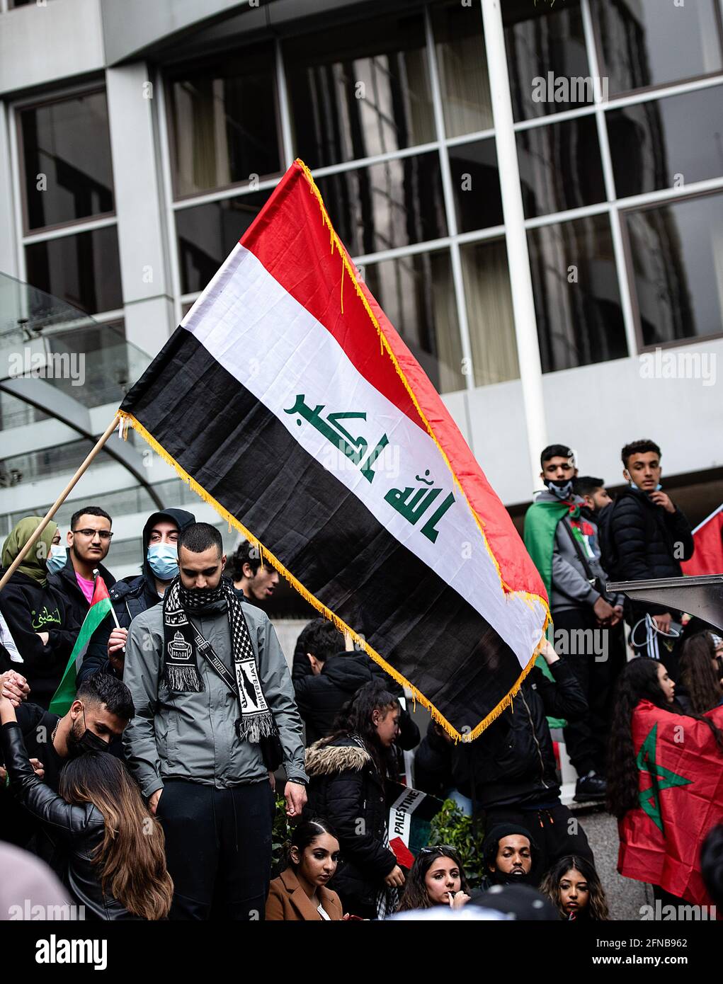 London, UK. 15th May, 2021. Protester waving a large flag outside of ...