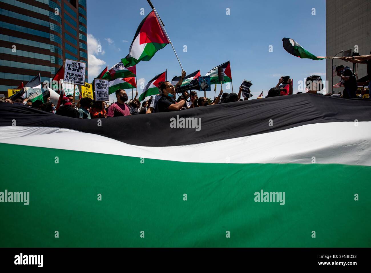 Los Anglees, California, USA. 15th May, 2021. Protesters carry a giant ...