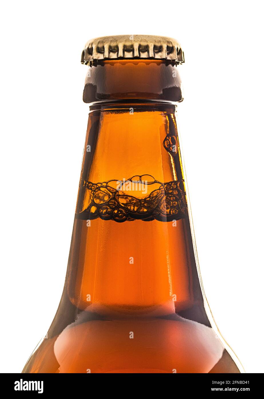Neck of a brown beer bottle with cap showing the bubbles on a white ...